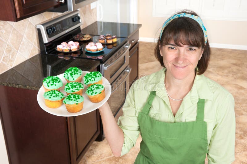 Homemaker holding cupcakes stock image. Image of cupcake - 17381111