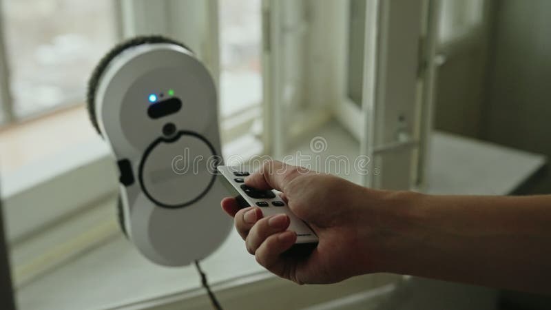 Homeowner Using Automatic Window Cleaning Robot with Remote Control at ...