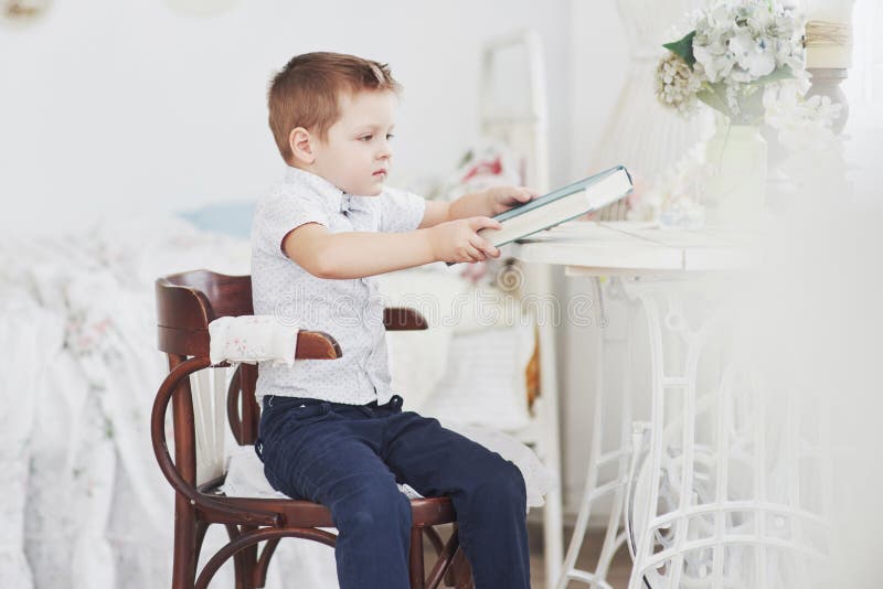 Homework and School Concept - Bored Student Boy Reading Book or ...
