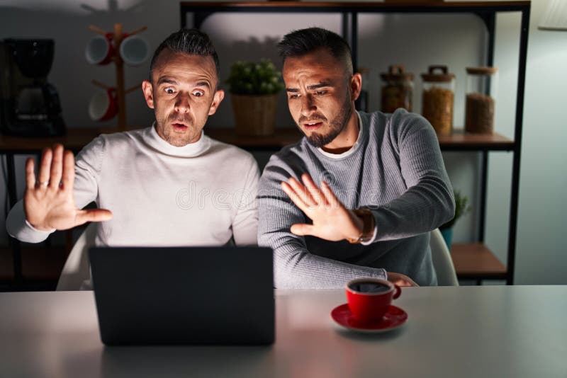Homosexual Couple Using Computer Laptop Doing Stop Gesture with Hands ...