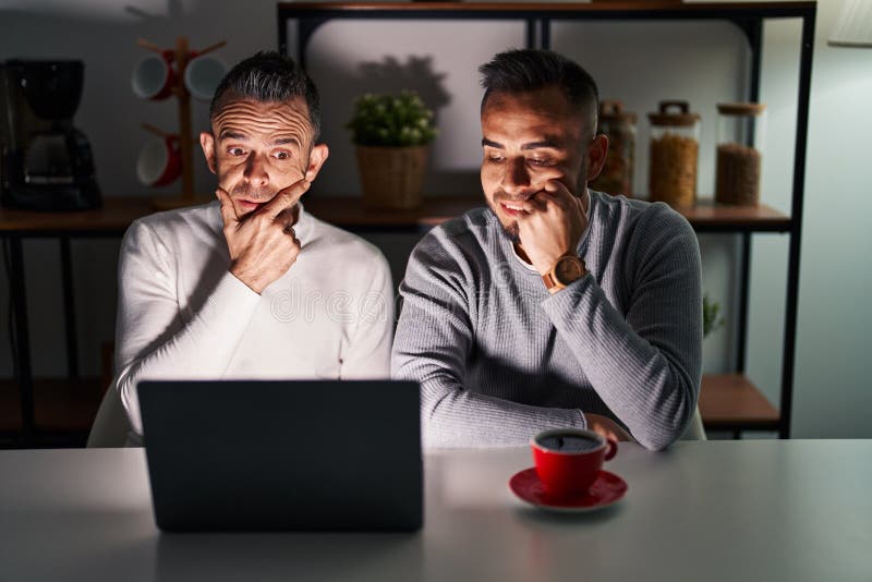 Homosexual Couple Using Computer Laptop Looking Stressed and Nervous ...