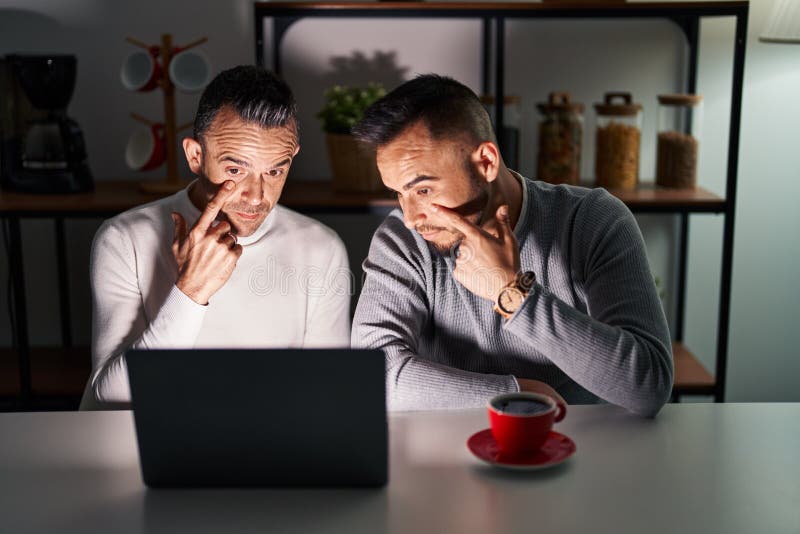 Homosexual Couple Using Computer Laptop Pointing To the Eye Watching ...