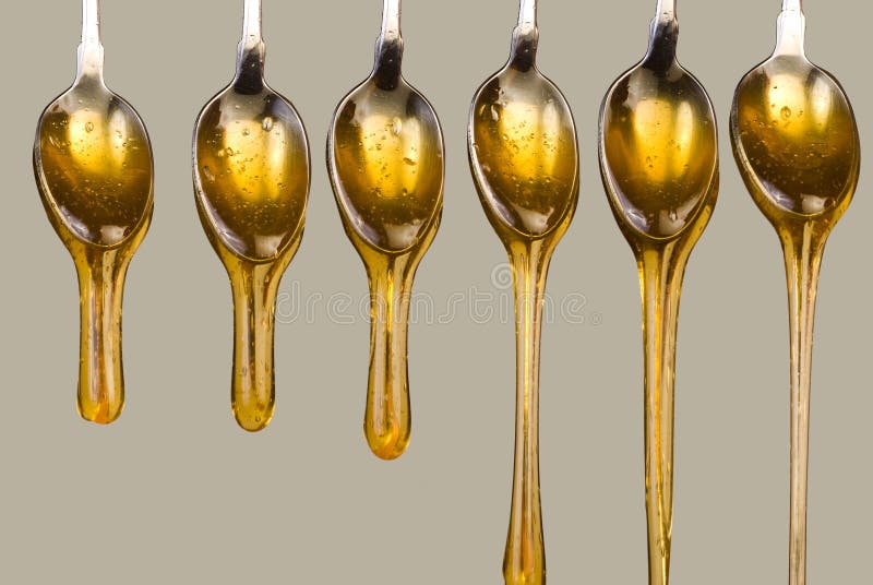 Honey dripping teaspoons stock photo. Image of spoon - 21734792