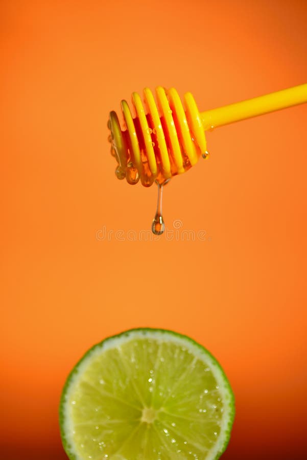 Honey Flowing on Lemon Over Background Stock Image - Image of drizzler ...