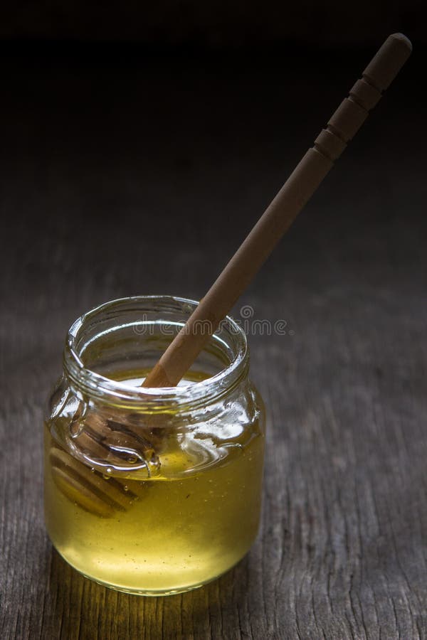 Honey in Jar with Wooden Stick on a Table Stock Photo - Image of ...