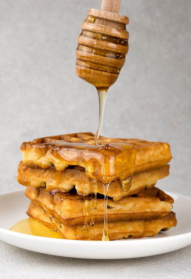 Honey Pouring on a Fresh Waffles. Breakfast with Belgian Waffles Stock ...