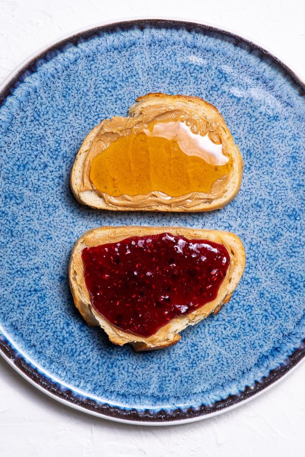 Honey, Raspberry Jam and Peanut Butter on White Bread Stock Photo ...