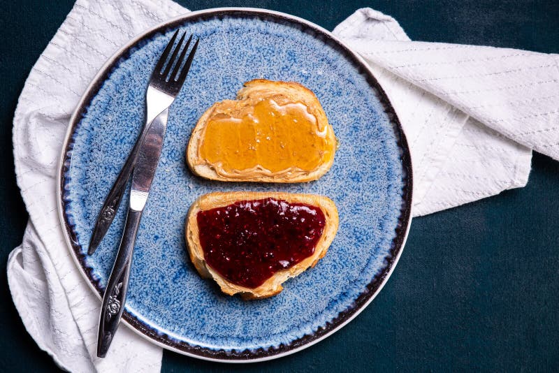 Honey, Raspberry Jam and Peanut Butter on White Toast Stock Photo ...