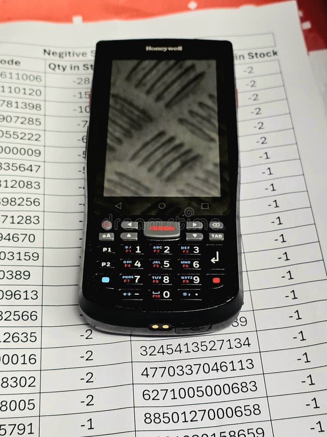 A Honeywell EDA51K Handheld Barcode Scanner Resting on a Sheet of Paper ...