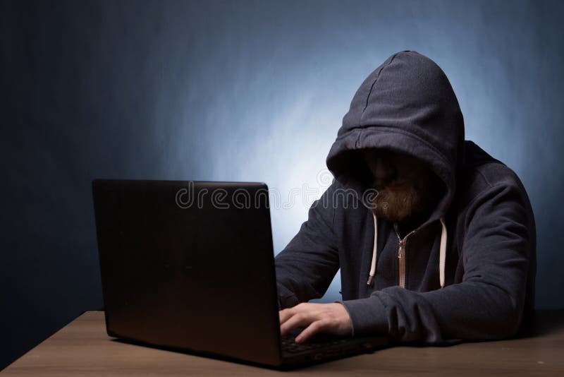 Hooded Computer Hacker Stealing Information with Laptop Stock Photo ...