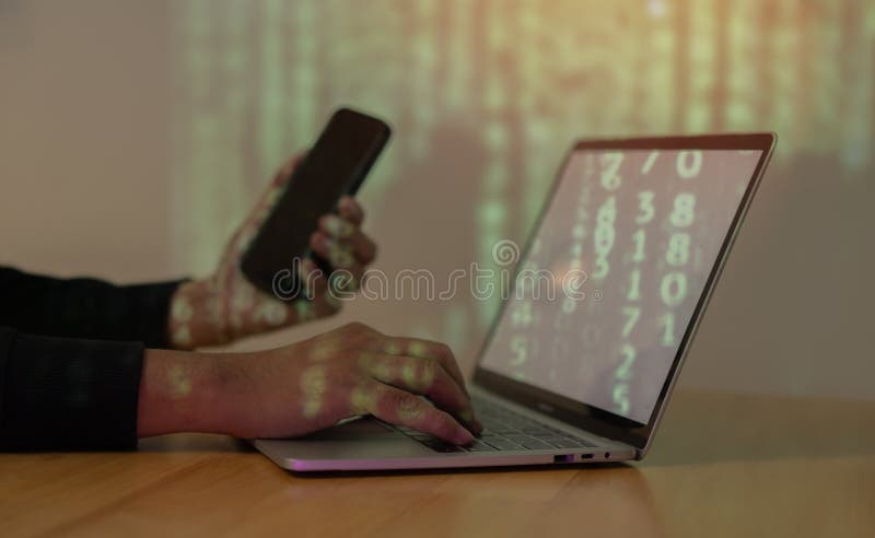 Hooded Computer Hacker Use Phone and Stealing Information with Laptop ...