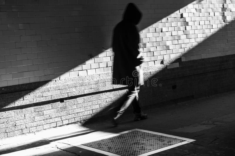 Hooded man in shadow stock photo. Image of coat, shadow - 48479588