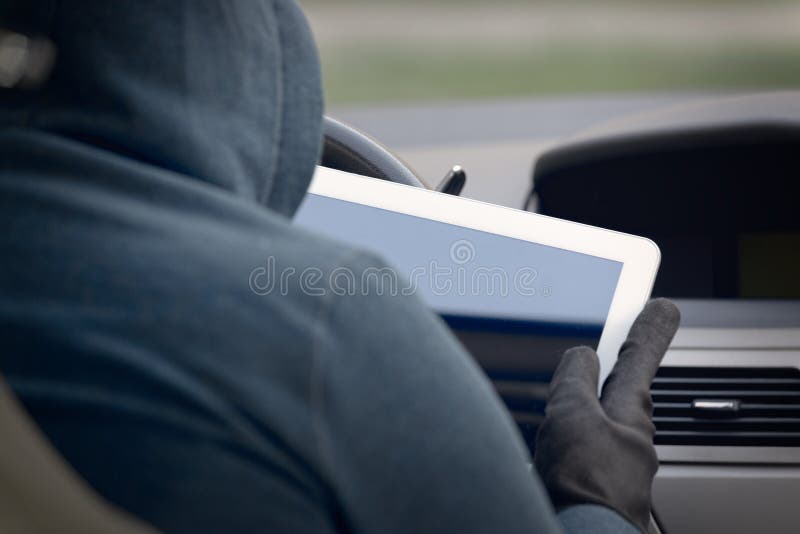 Hooded Thief Tries To Break the Car`s Security Systems with Tablet ...
