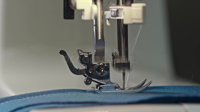 A Hook with a Needle Sews on the Fabric. Cutting and Sewing on a Sewing ...