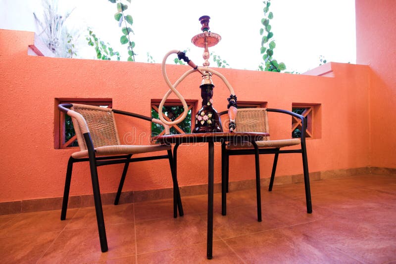 Hookah on table and chairs stock photo. Image of cafe - 7850486