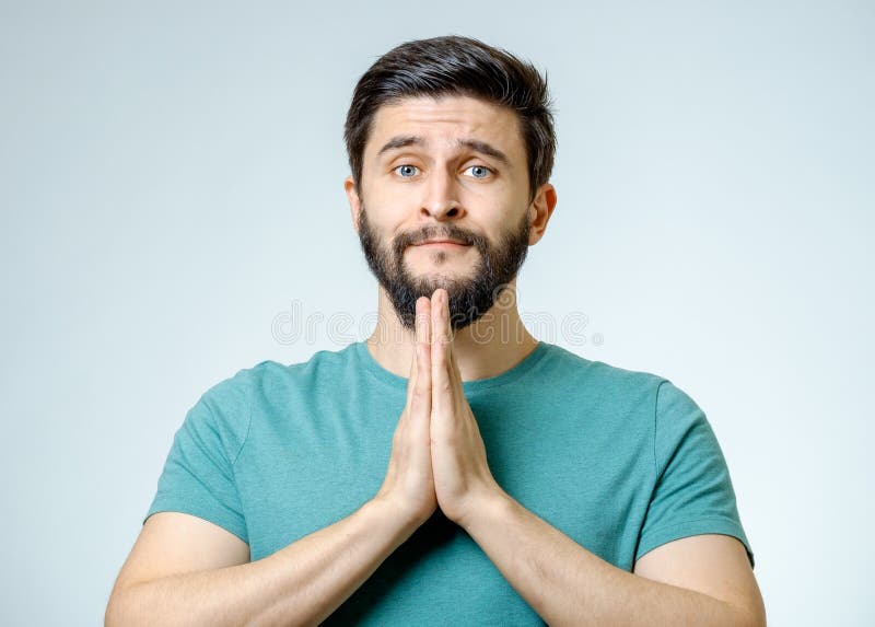 Hopeful young man praying stock image. Image of fashion - 88396431