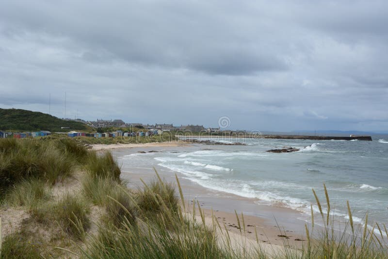 Hopeman Bay with Harbour and Beach Huts Stock Image - Image of choppy ...