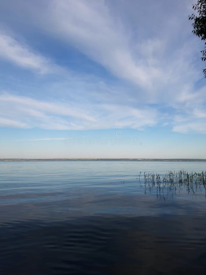 Horizon Line on the Calm Water of the River. the Clear Sky is Reflected ...