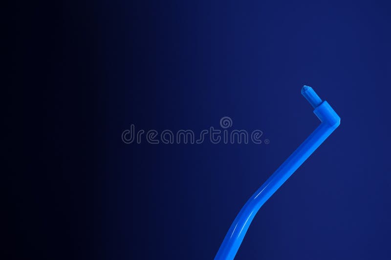 A Blue Monobundle Plastic Toothbrush on a Blue Background. Horizontal ...