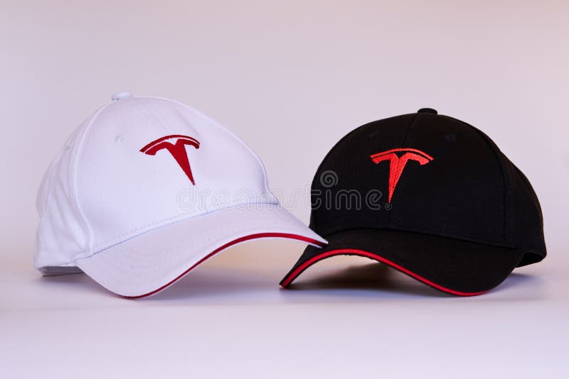 Horizontal Close-up of Two Black and White Caps with Tesla Logotype in ...