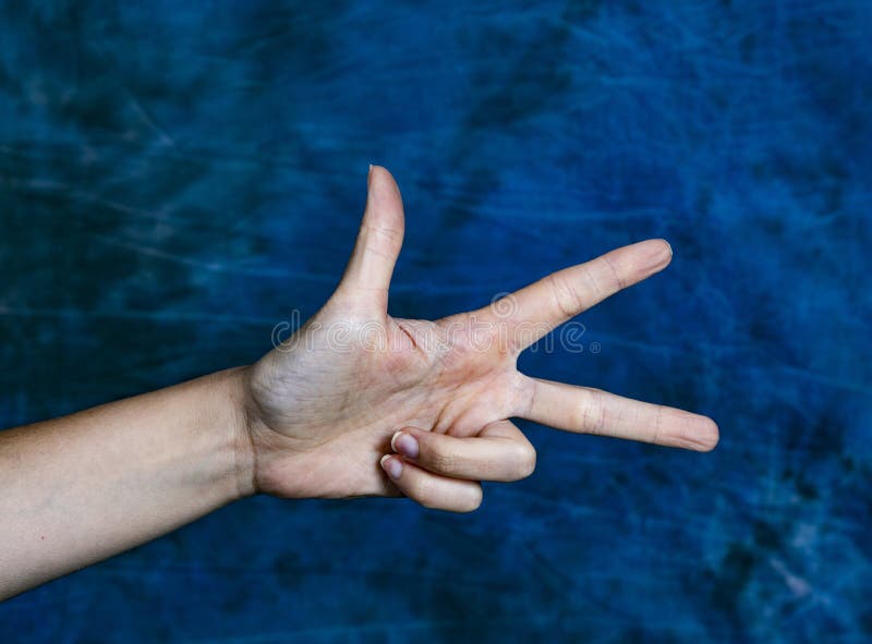 Horizontal Closeup Shot of a Hand Showing Number Three on a Marbled ...