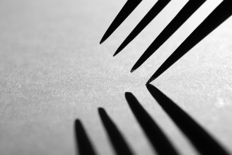 Harsh Shadow Cast by Sharp Fork Prongs on a Gray Paper Stock Image ...