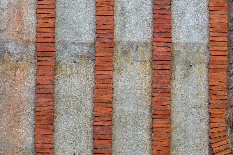 Horizontal Image of a 4 Columns of Red Bricks in Front of Gray Cement ...