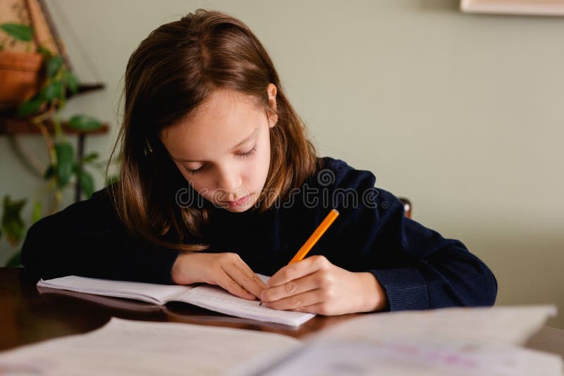 Horizontal Image of a Little Brown-haired Girl Doing Some Homework ...