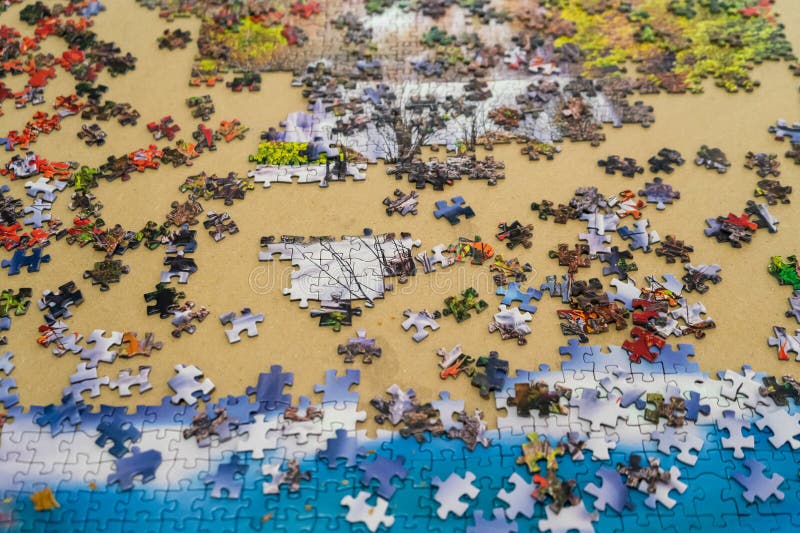 Horizontal Image of a Puzzle Under Construction with Pieces Scattered ...