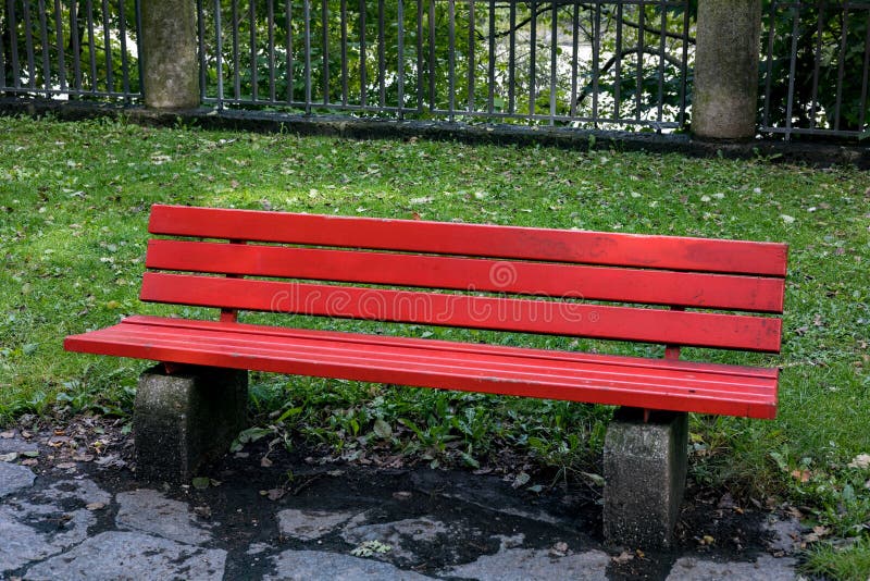 Horizontal Image of a Red Bench Near the Street in the Background of ...