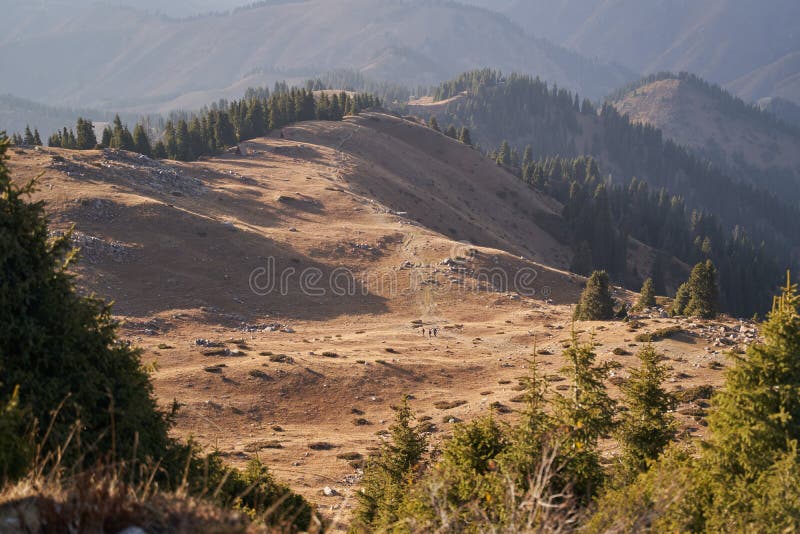 Horizontal Landscape with a Trekkers Going by a Mountain Path at Golden ...