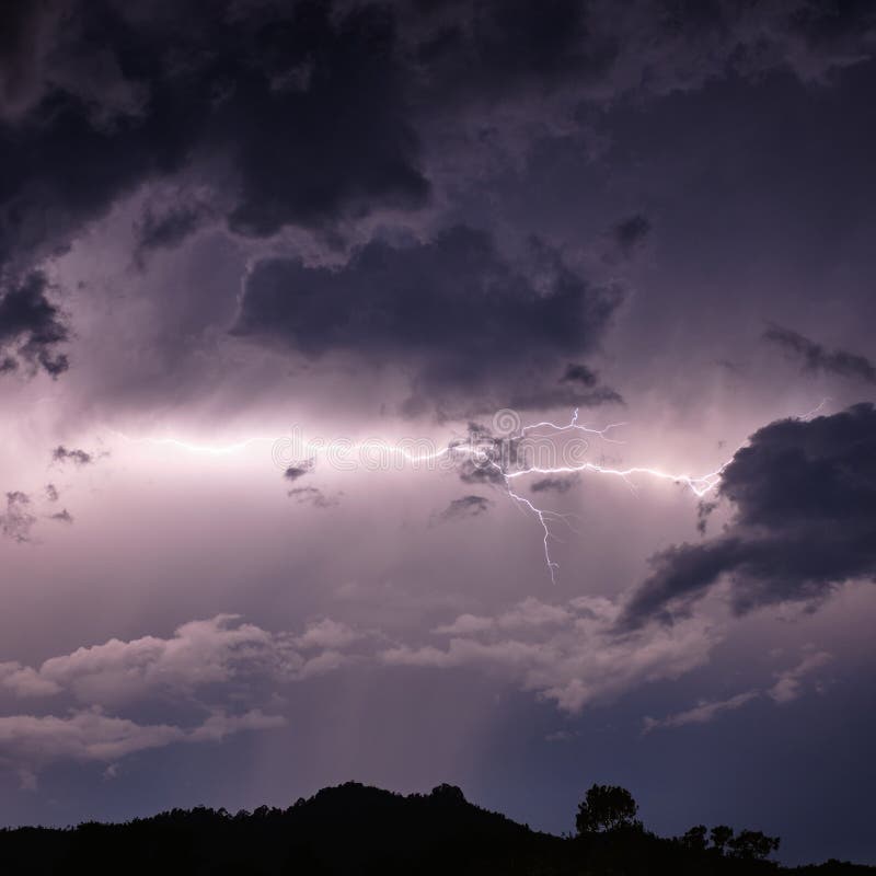 Horizontal Lightning Bolt among Storm Clouds Stock Photo - Image of ...
