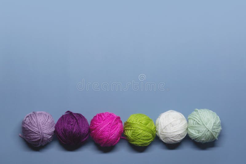 A Horizontal Line of Balls of Thread on a Blue Background Stock Image ...