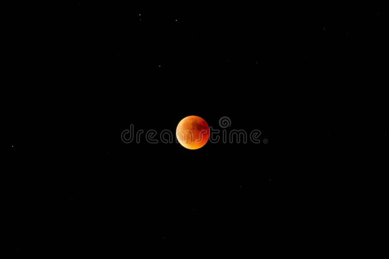 Horizontal Long Shot of an Orange and Red Moon in the Dark Sky at Night ...