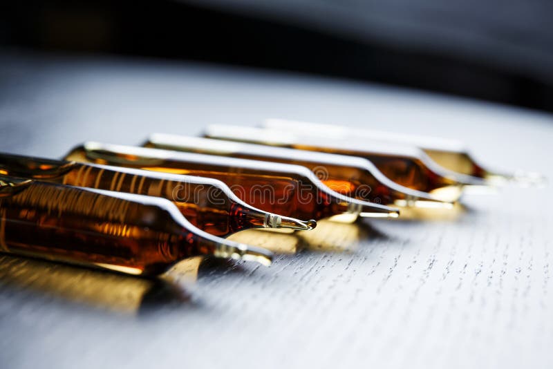 Many Brown Ampoules Set in Pharmaceutical Packaging White Container ...