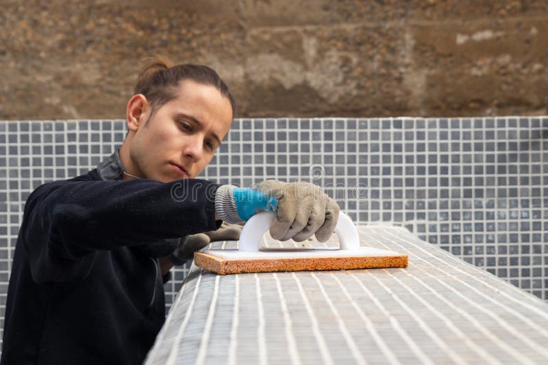 Young Man Working on the Construction of a Swimming Pool with Sponge ...