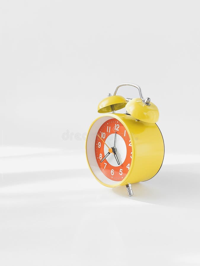 Horizontal Photo of Bright Yellow Orange Round Alarm Clock with on ...