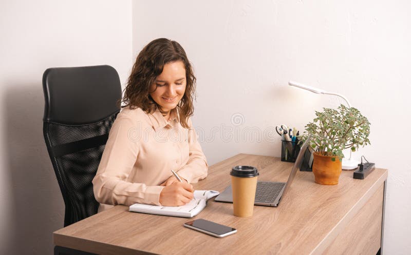 Horizontal Photo of Happy Young Office Worker Making Notes in Agenda ...