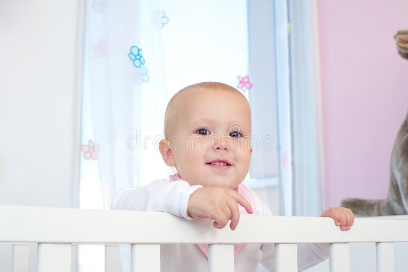 Horizontal Portrait of an Adorable Baby Smiling in Crib Stock Photo ...