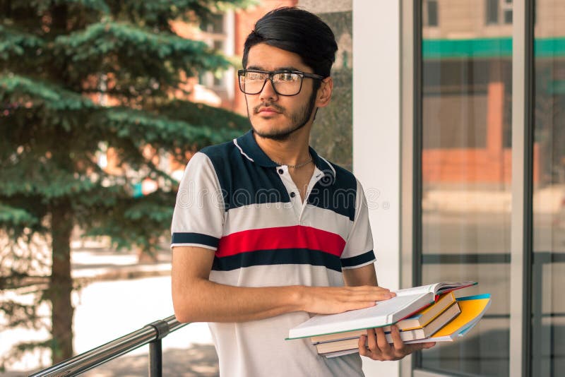 Horizontal Portrait of a Stylish Man in Glasses with Books Stock Image ...