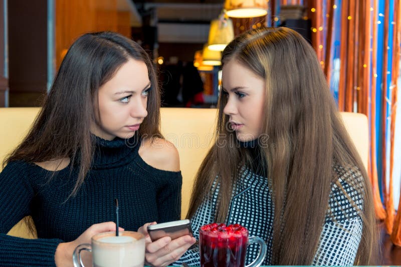 A Horizontal Portrait of Two Friends in a Cafe are Shared Stock Image ...
