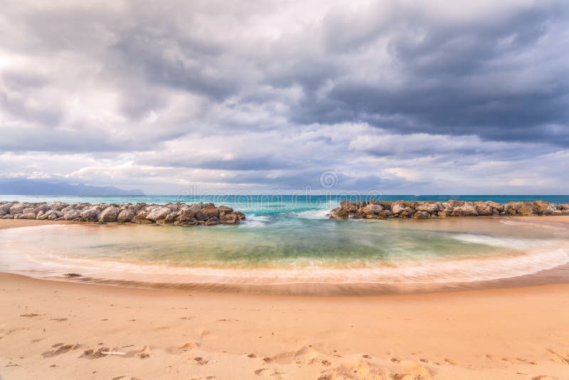 Horizontal Shot of a Beautiful Beach with Rocks Under the Breathtaking ...