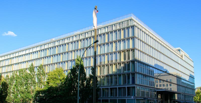 Horizontal Shot of a Big Building with Vertical Windows and a Small ...