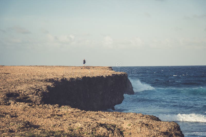 Horizontal Shot of a Man Walking on a Cliff Next To the Sea in Aruba ...
