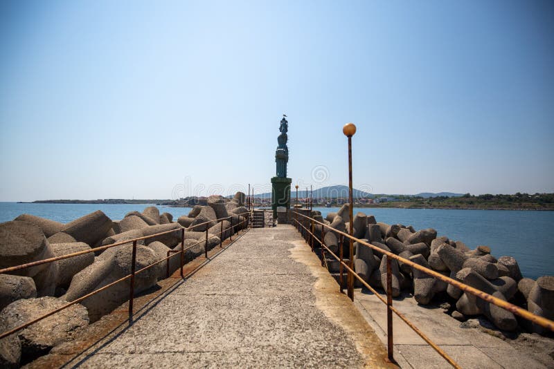 Horizontal Shot of the Ocean from a Stone Pier with a Statue Stock ...