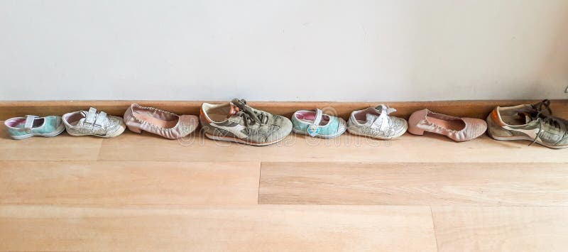 Horizontal Shot of a Range of Shoes Under the Wall Stock Photo - Image ...