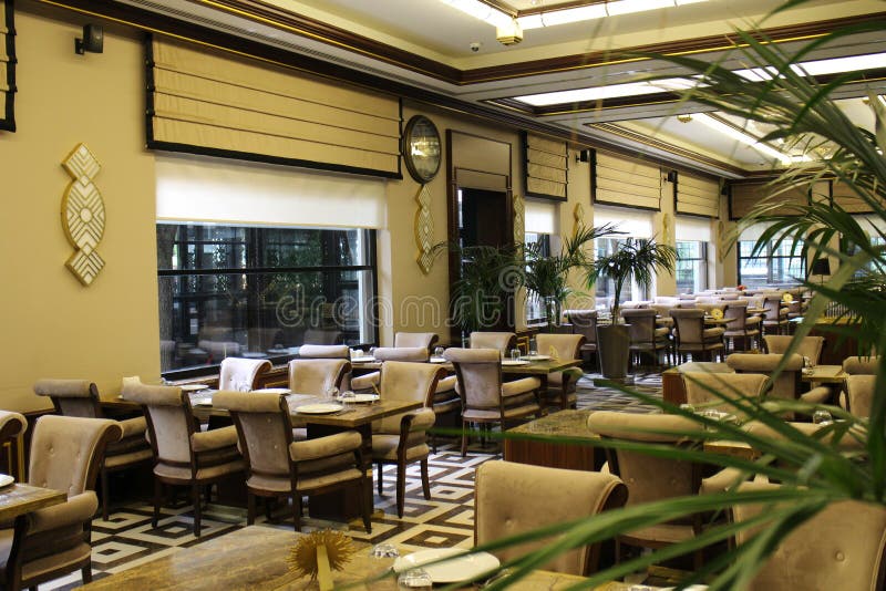 Horizontal Shot of a Restaurant with Rectangular Beige Wooden Tables ...