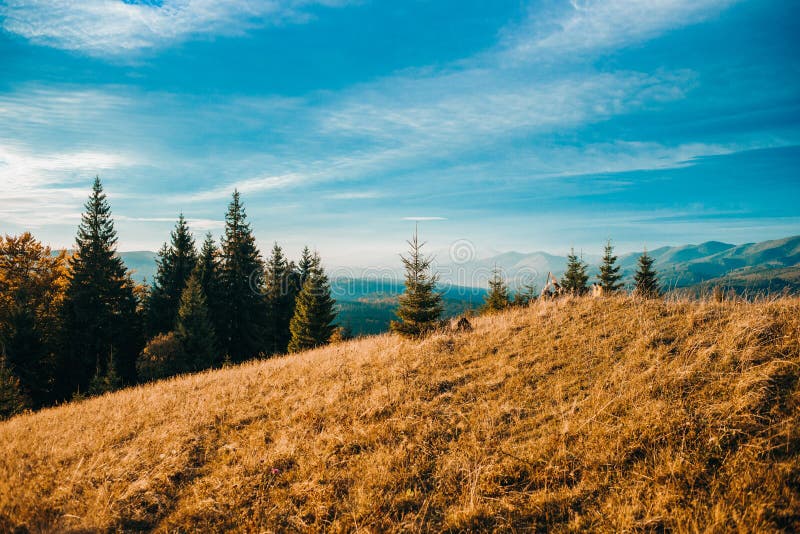 Horizontal Shot of the Rising Sun and High Mountains Under the Cloudy ...