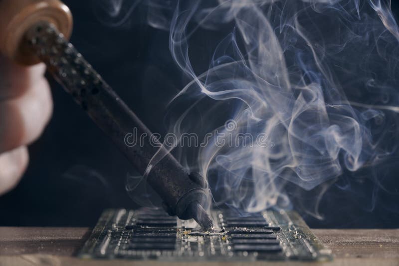 Backdrop of Smoking Soldering Iron on Dark Background. the Concept of ...