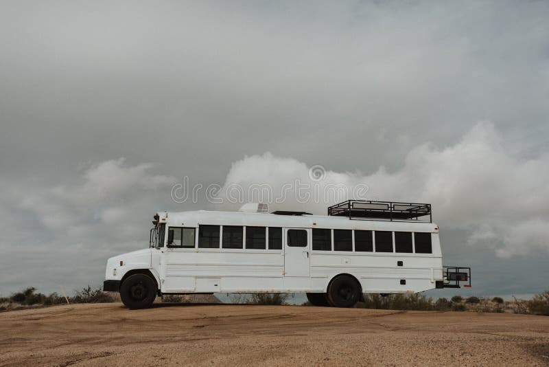 Horizontal Shot of a White Bus from the Side in a Dry Field during ...